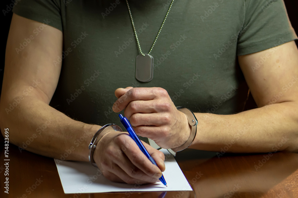 Handcuffed military soldier signs statement for investigation ...
