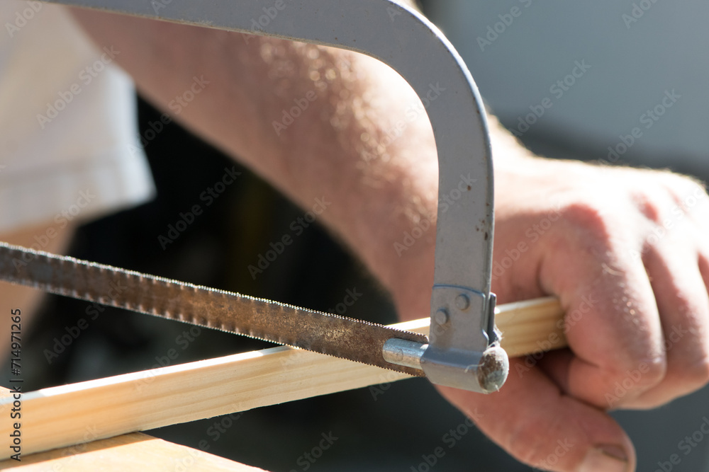 Hand saw with hardened teeth isolated. saw in hand, hacksaw at work ...
