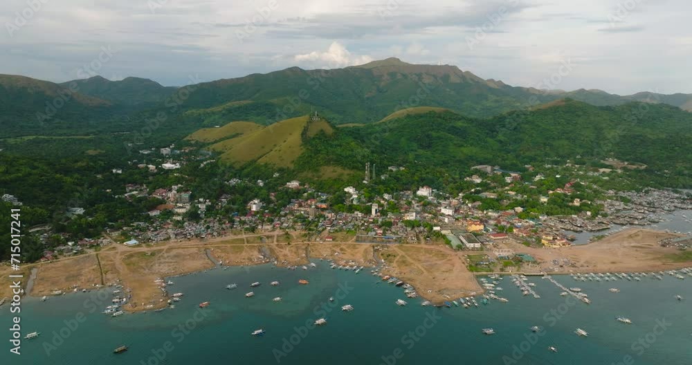 Pier with tour boats in Coron Town Proper. Mountain hills, view from ...