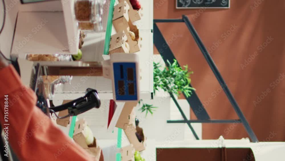 Vertical Video Retailer scanning products and using scale at checkout ...