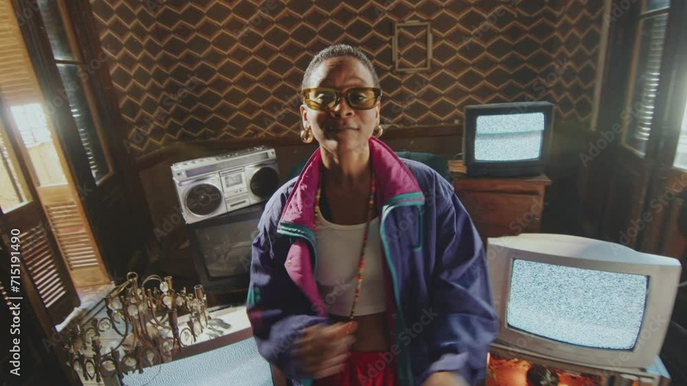 Stylish African-American girl in 80s tracksuit dancing in a retro ...