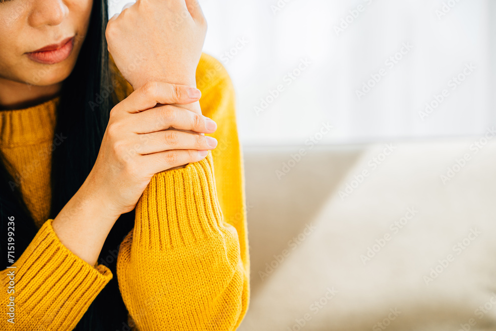 Illustrating hand pain, Woman holds her achy wrist indicating Carpal ...