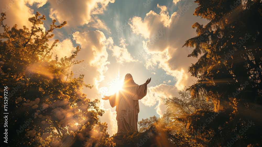 Fotka „Statue of Jesus Christ with outstretched arms surrounded by lush ...