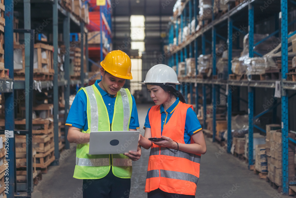 Warehouse management team using computer laptop check stock inventory ...