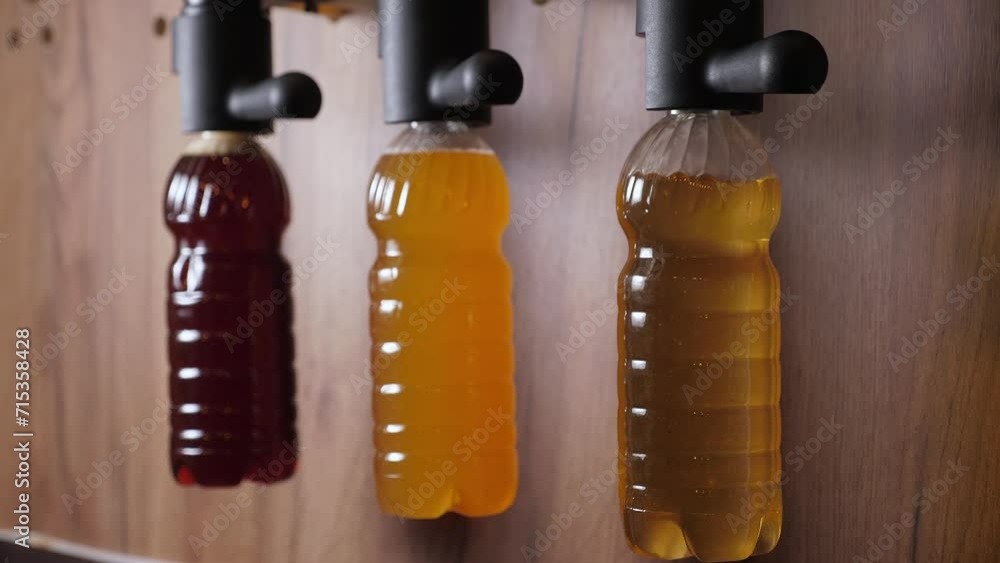 A bar counter with draft beer. Draft beer in plastic bottles. Three ...