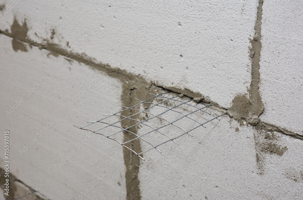 Close up on autoclaved aerated concrete (AAC) wall with steel wire mesh ...