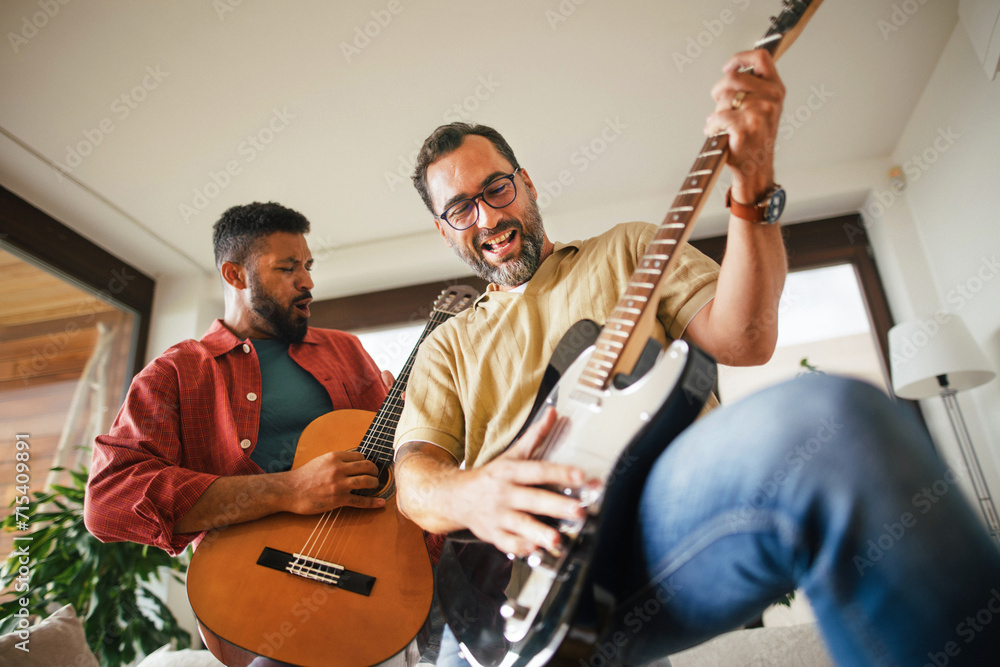 Best friends, musician jamming together. Playing music on guitar ...