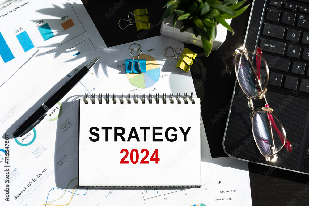 Strategy 2024 list with notebook, plant on office table. Resolutions ...