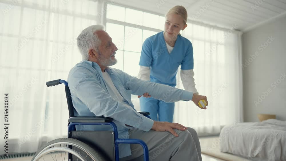 Nurse woman cares old man in wheelchair. Paralyzed elderly man does ...
