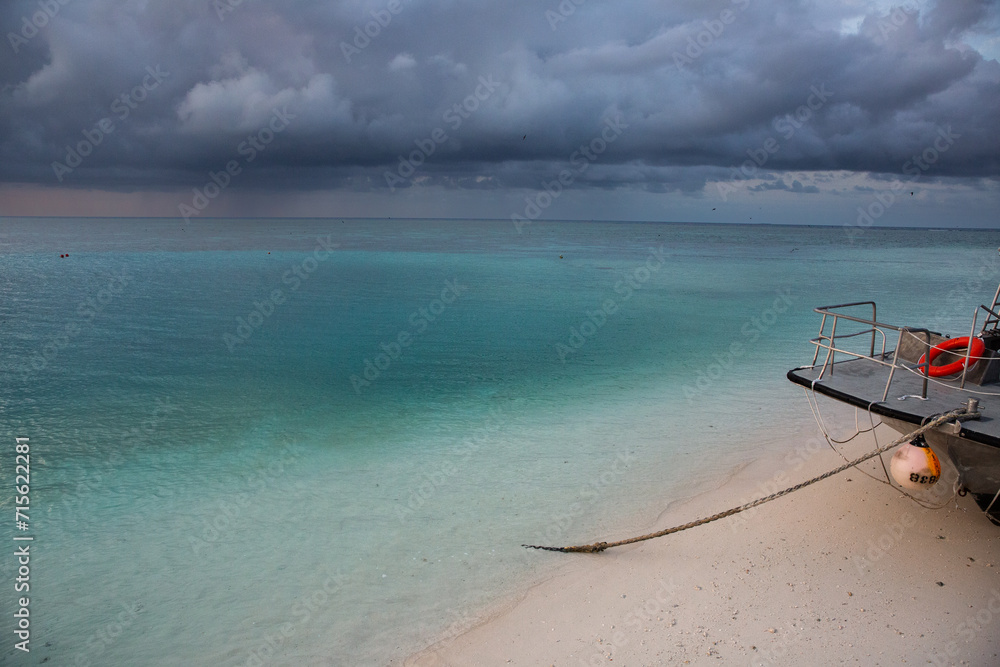 rain coming in towards Heron Island with a dive boat tied up on the ...