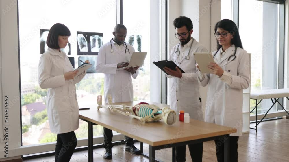 Young multiethnic medical students on anatomy lesson in modern ...