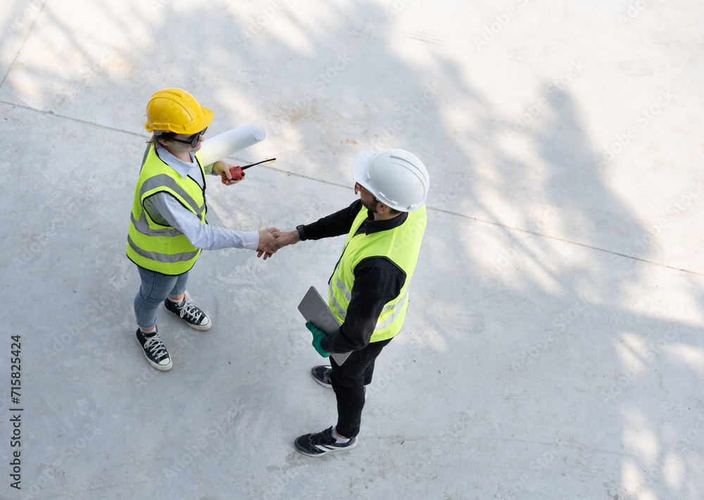 Caucasian engineer man hand shake engineer woman and working with paper ...