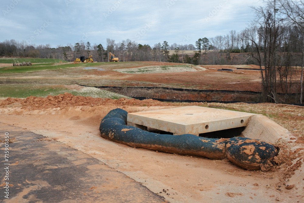 Storm drain surrounded by a filter sock to prevent erosion runoff in ...