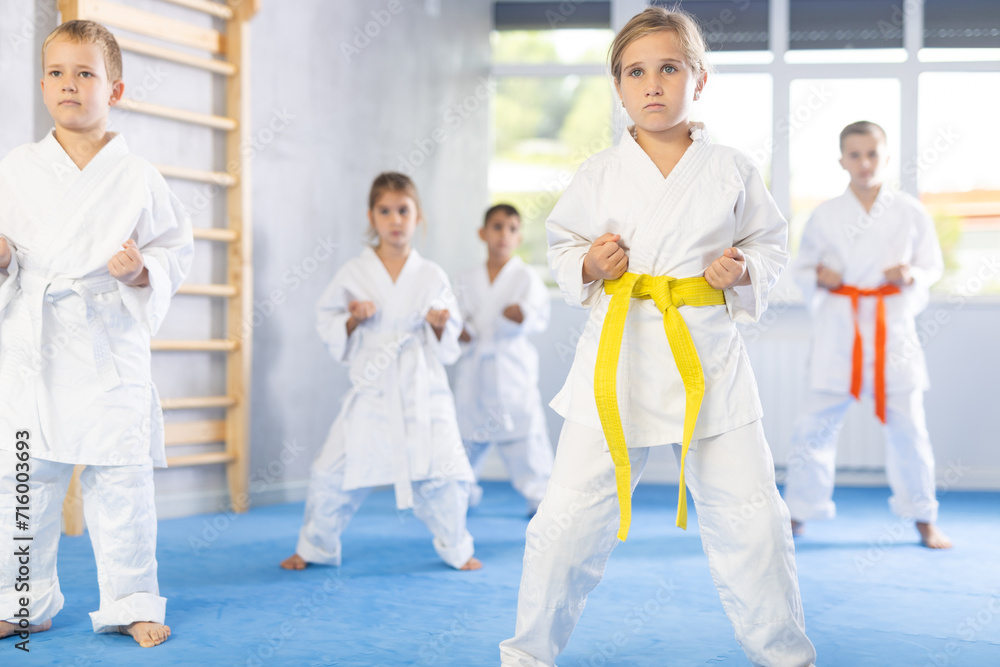 Children athletes starting position and studying and repeating sequence ...