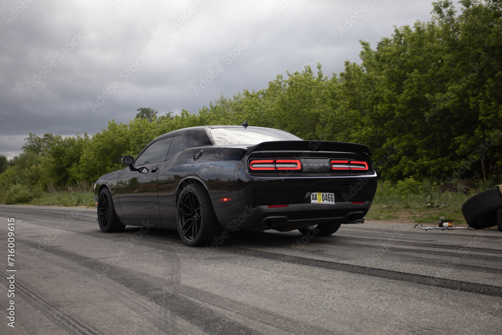 car driving on the road black Dodge Challenger SRT Hellcat detail Stock ...