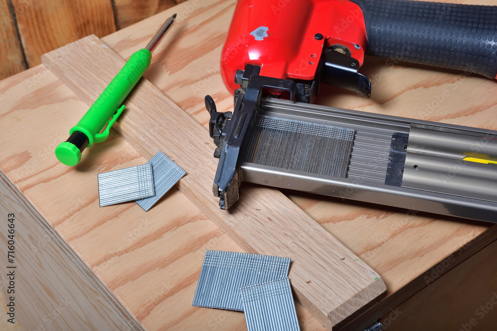 Reloading nail into pneumatic gun nailer for woodworking. Air nailer ...