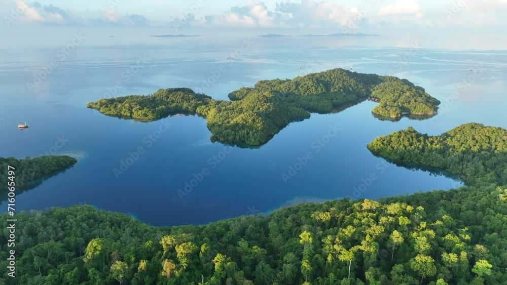 Early sunlight illuminates calm seas around the islands of Gam and ...