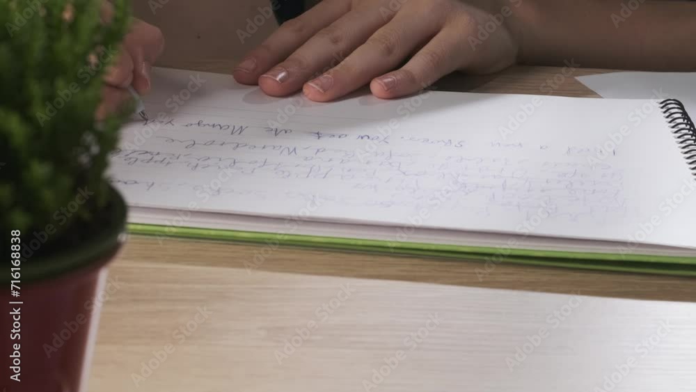 schoolchild doing homework, copying words English, child writes in ...