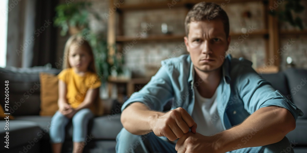 Man threatening kid daughter with his fist. Scared child sitting ...