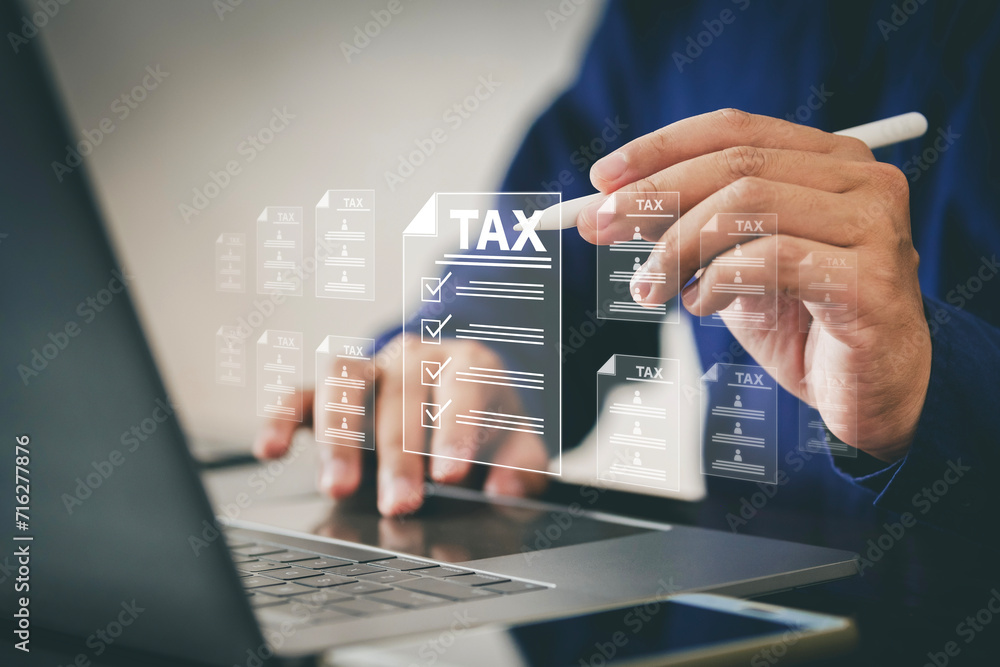 Tax concept. Person using computer to fill out personal income tax return to pay taxes online ...