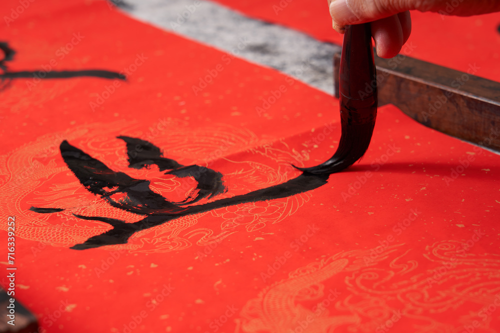 An old calligrapher writes couplets during the Chinese Year of the ...