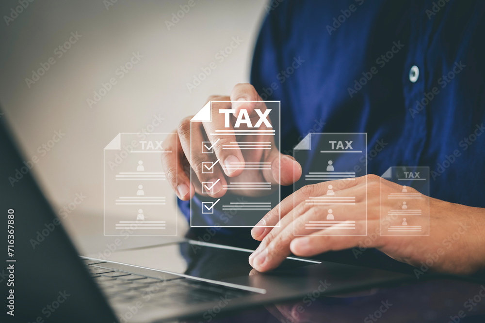 Tax concept. Person using computer to fill out personal income tax return to pay taxes online ...