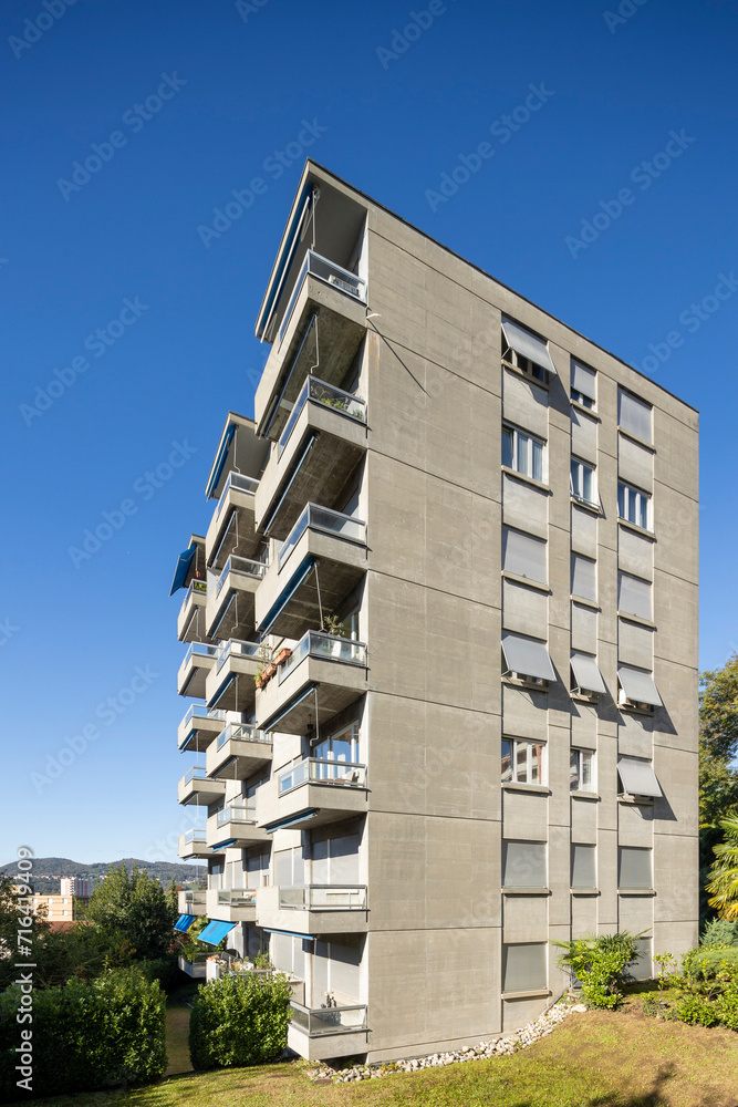 Exterior view of an old rough concrete apartment building with ...