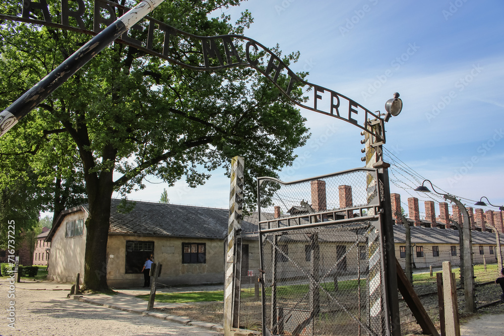 Entrance to concentration camp Auschwitz, Oswiecim. Barbed wire fence ...