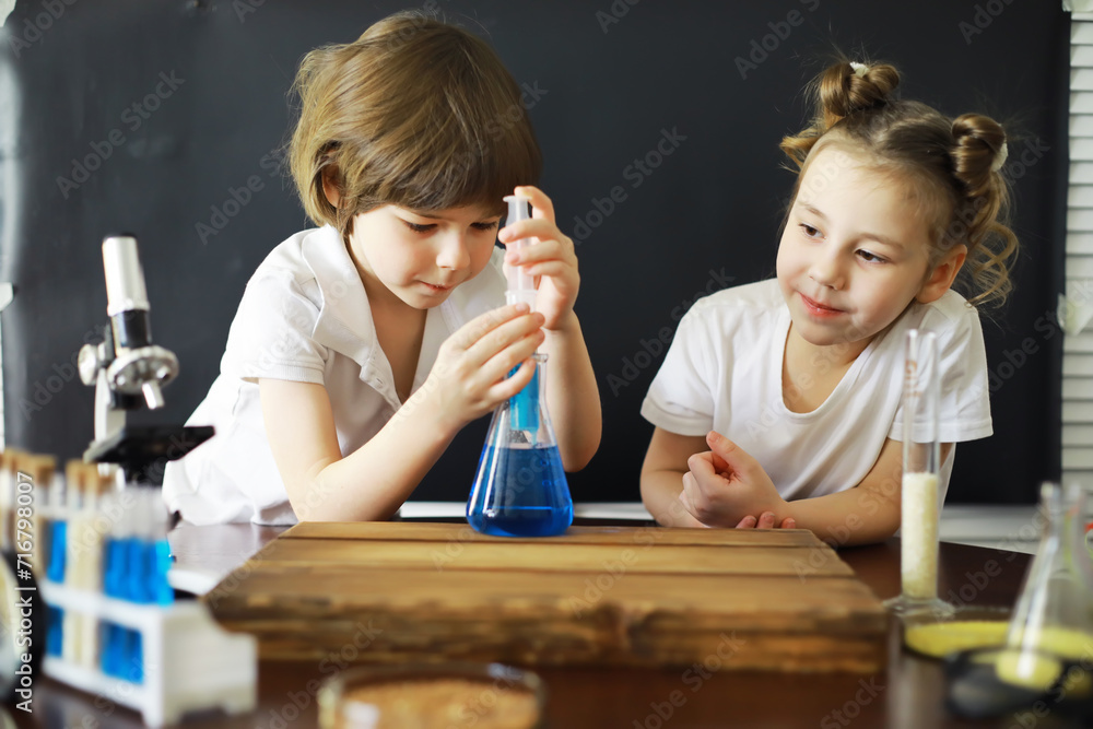 Children scientists. Schoolchildren in the laboratory conduct ...