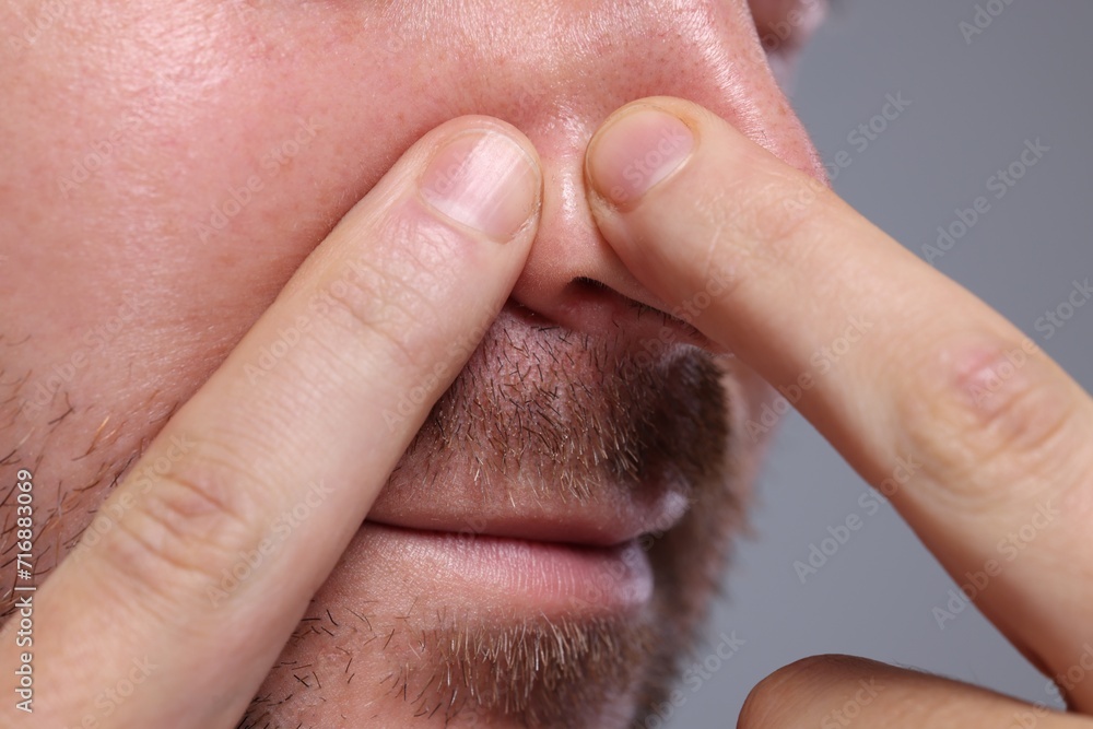 Man popping pimple on his nose against grey background, closeup Stock ...