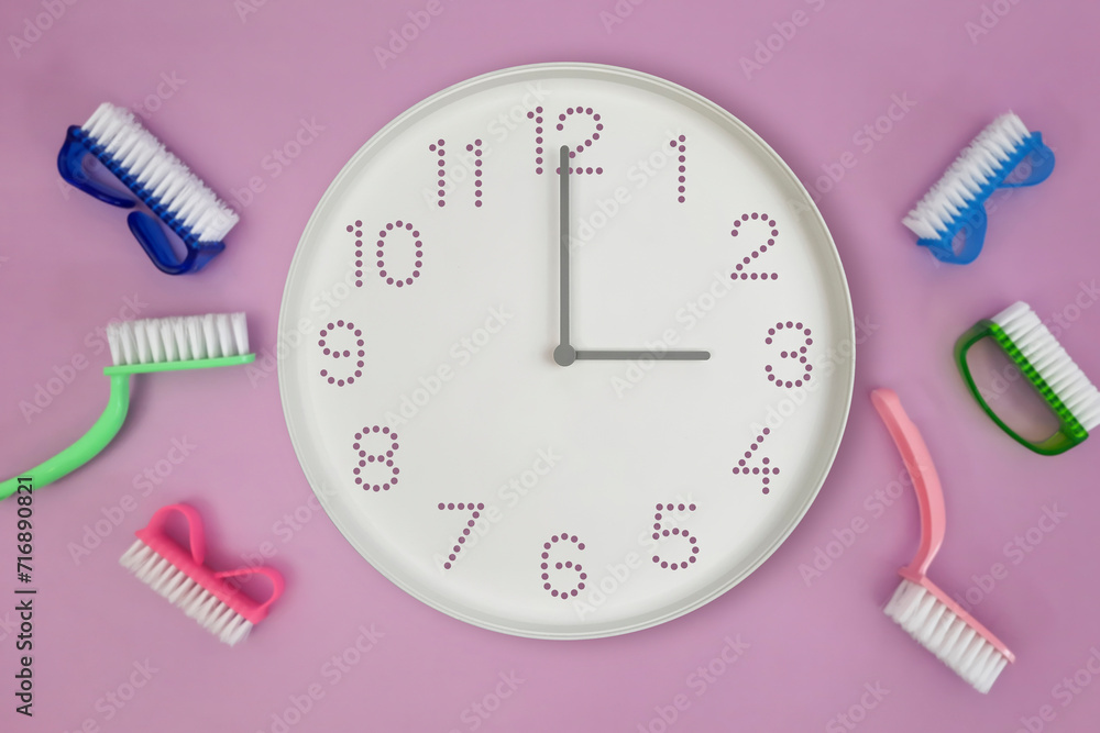 3 o'clock, afternoon. Cleaning time. White wall clock on defocused ...