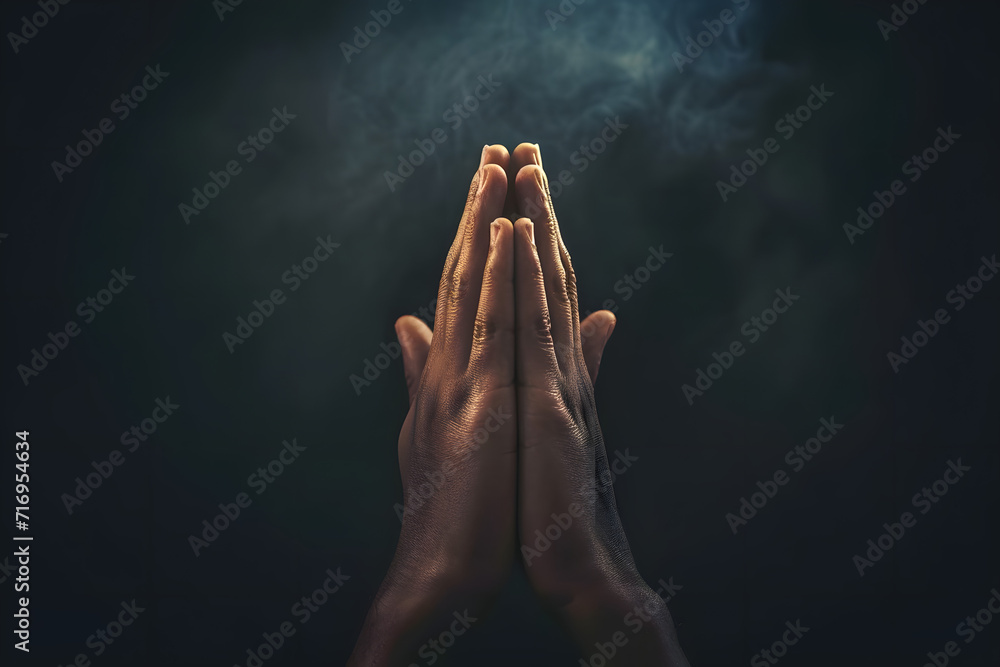 Praying hands with faith in religion and belief in God on dark ...