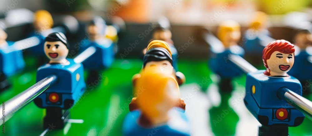 Toy foosball table with a green field, blue and white uniform. Stock ...