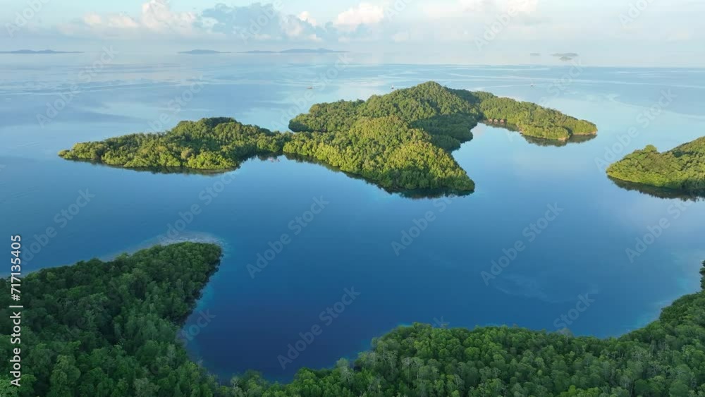Early sunlight illuminates calm seas around the islands of Gam and ...