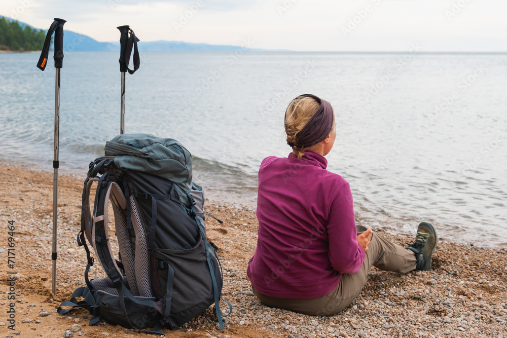 Hiking tourism adventure. Backpacker woman resting after hiking looking ...