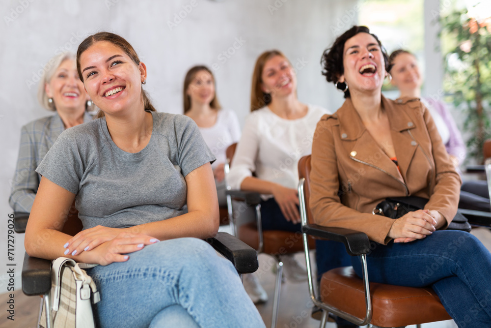small group of women are sitting in audience and listening to lecture ...