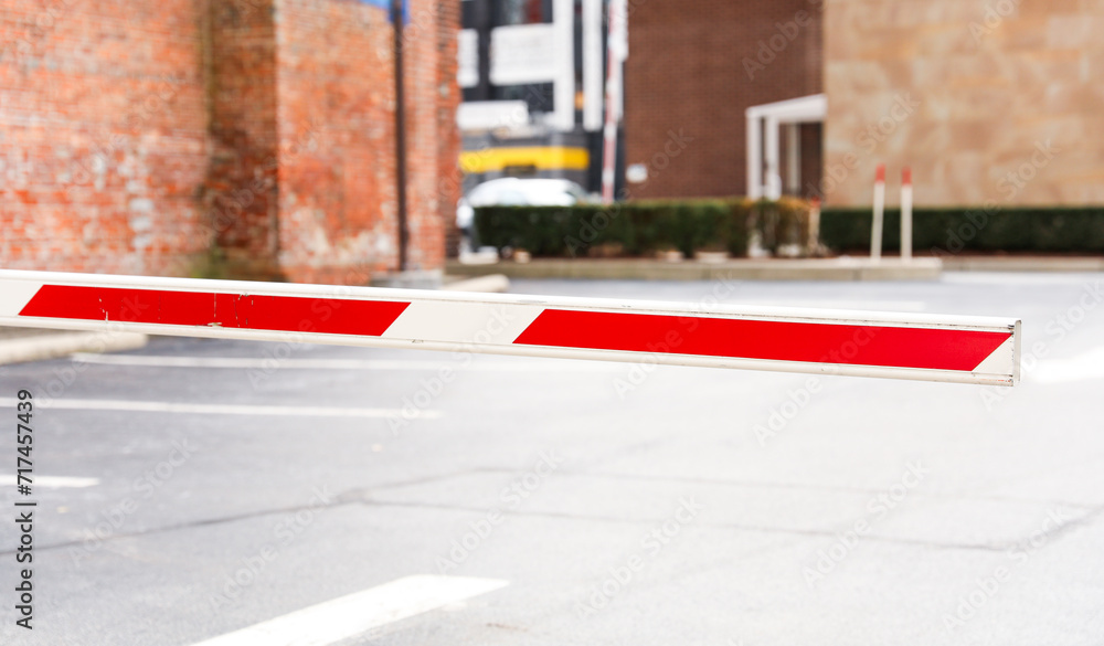 closed parking lot gate, representing barriers, access control, and ...
