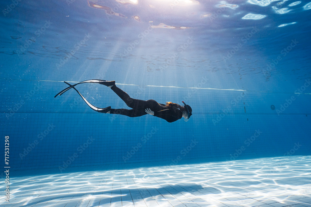 Beauty freediver Asian women diver with fins glides underwater in ...