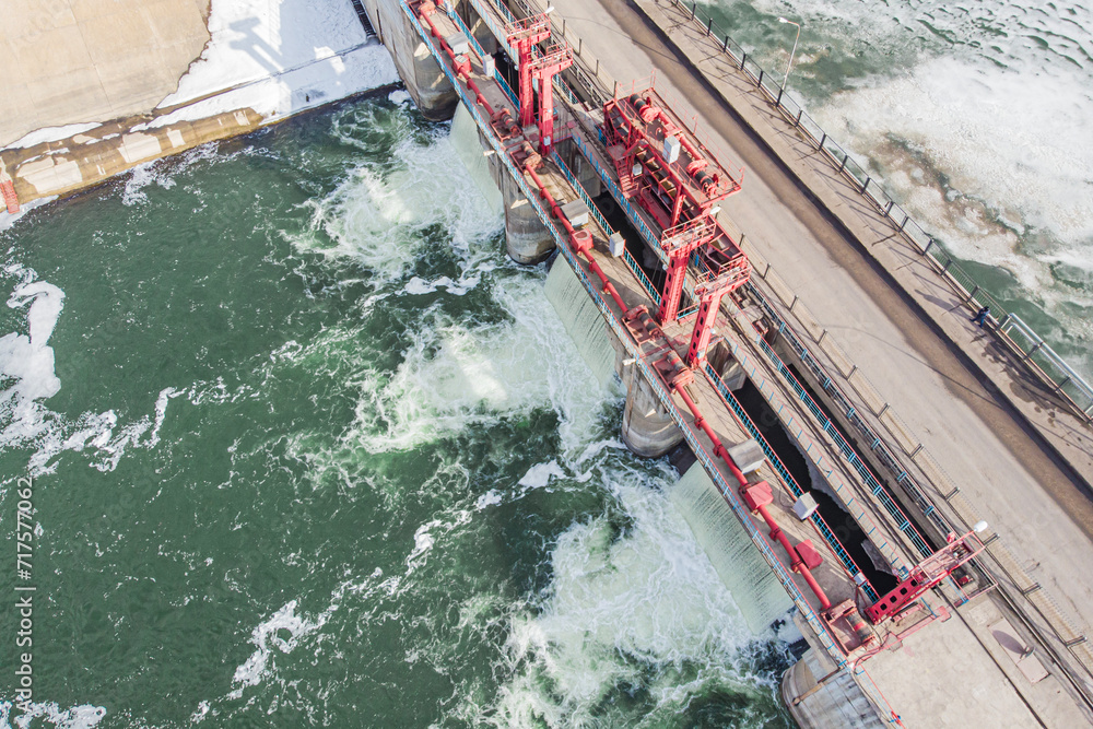 a dam across a river with a bridge in the spring before high water and ...