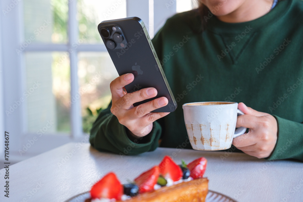 Jan 18th 2024 : A woman holding and using Iphone 15 pro max smartphone ...