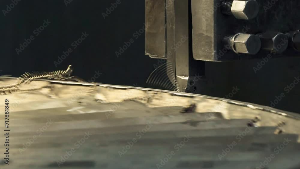 A Rotating lathe cutter tool is operating at the manufacturing facility ...