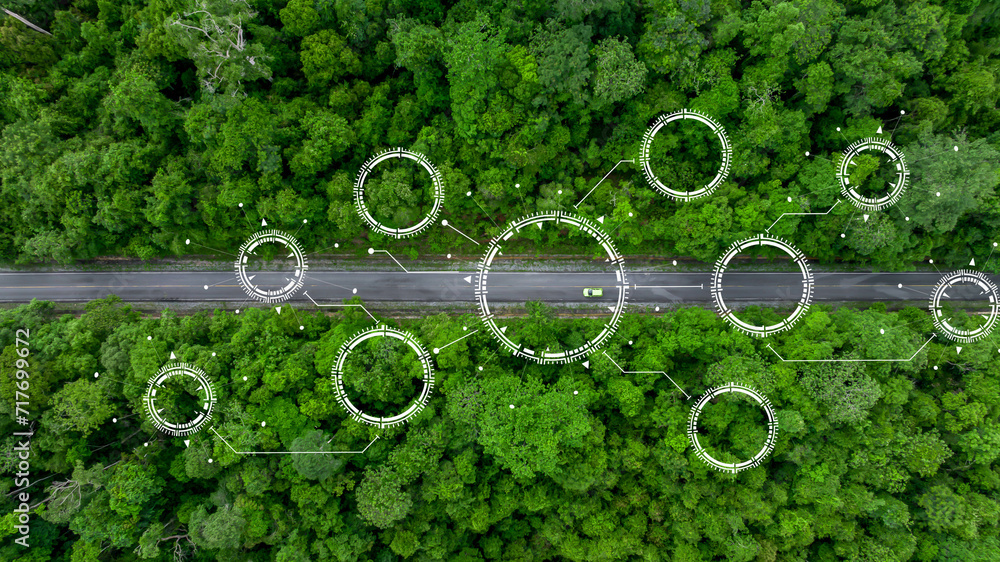 Aerial top view of green electric vehicle car driving over straight ...