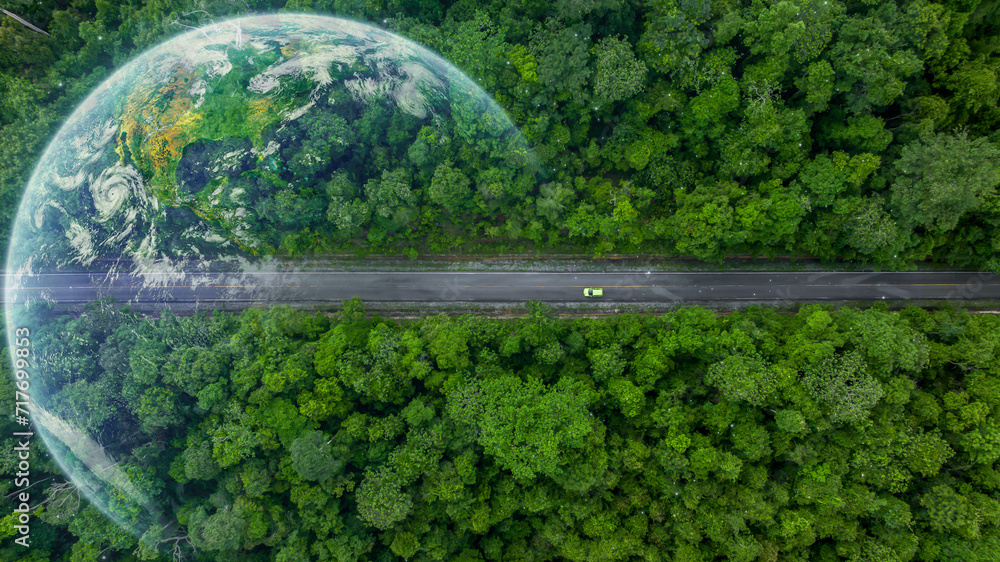 Aerial top view of green electric vehicle car driving over straight ...