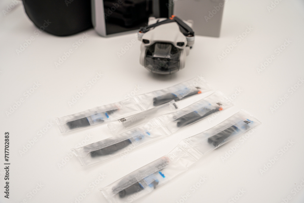 extra wings of four-winged camera drone in front of a white background ...