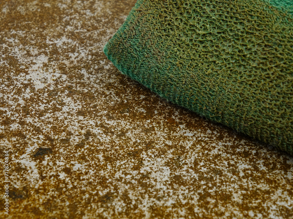 Rag with a solution of citric acid for primary rust removal on a ...