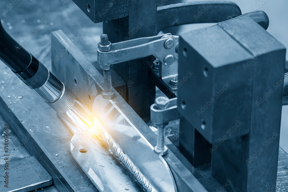 Close up scene the welding process by robotic system in the light blue ...
