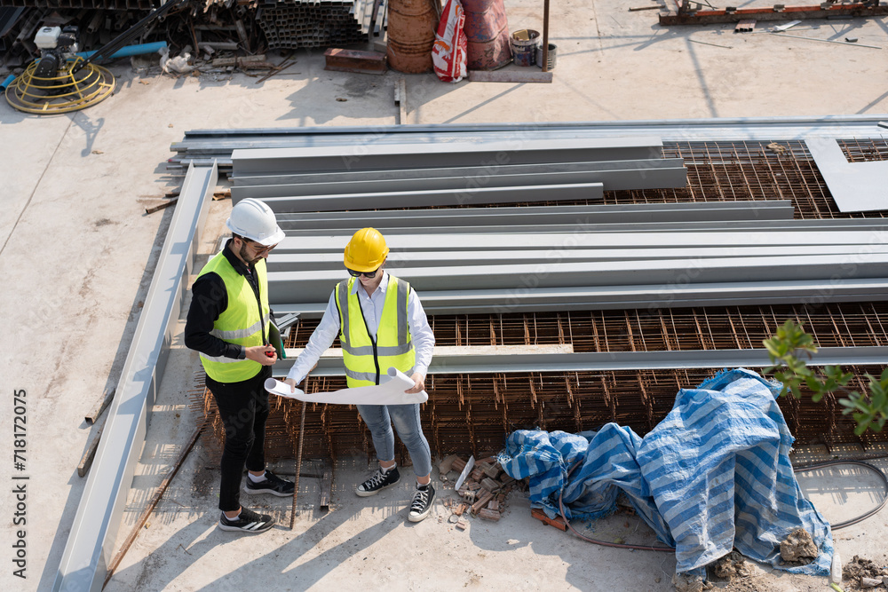 Caucasian engineer man and woman working with paper work and checking ...