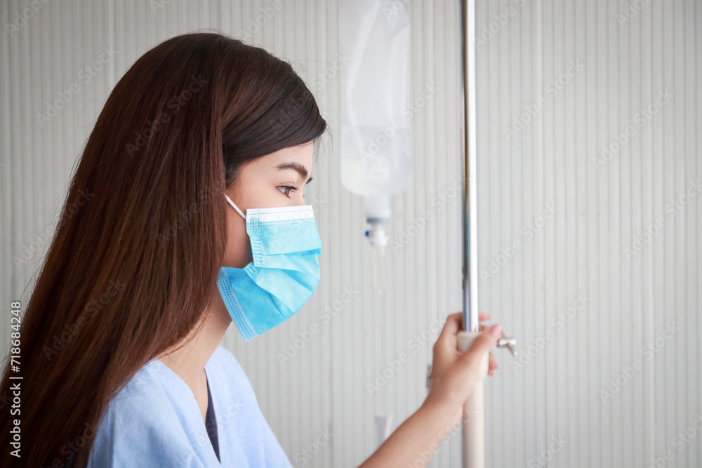 Asian woman wearing a mask while being treated in the hospital. Health ...