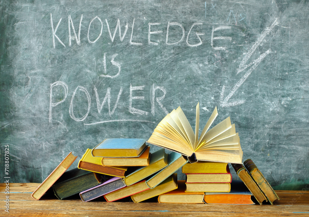 knowledge is power, books and blackboard with drawing of a lightning ...