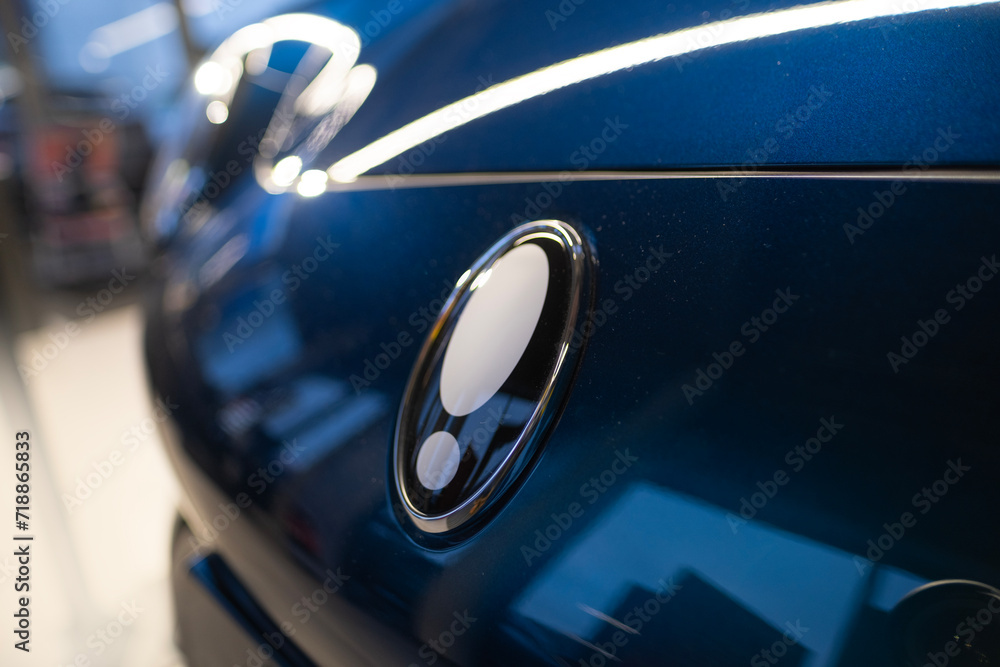 close-up Logo on cap, blue metallic electric car GWM ORA 03, automobile ...